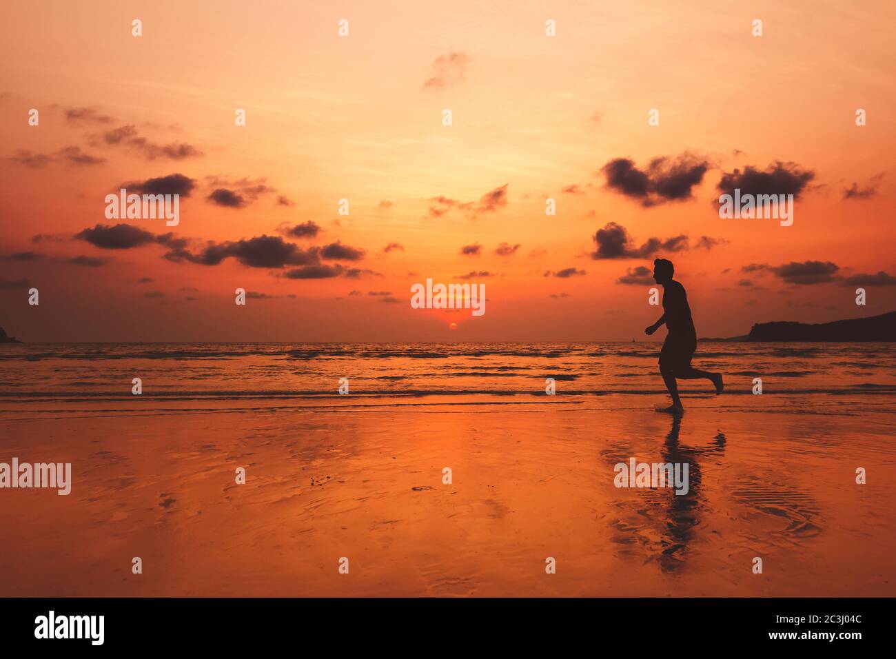 A man running at island and him running on the beach with sunset and ...