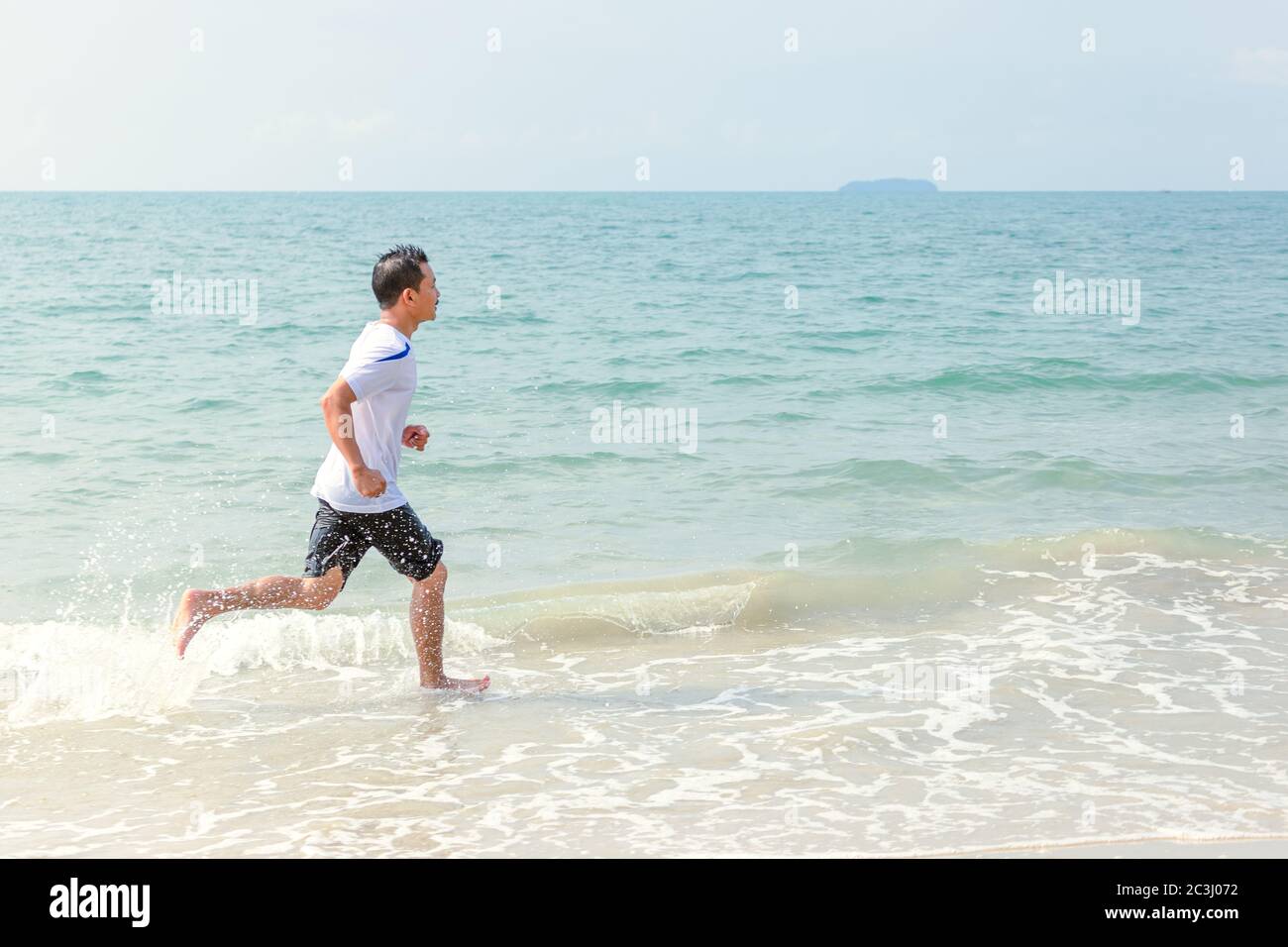 A man runing on the beach Stock Photo - Alamy