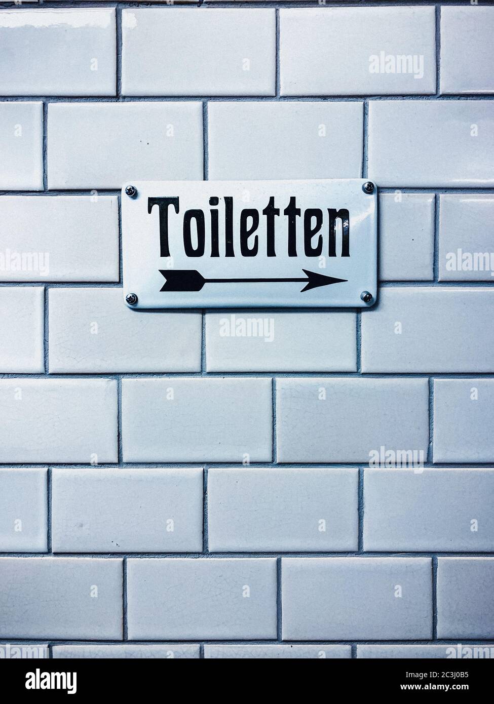 Closeup vertical shot of a toilet sign with a german writing Stock ...