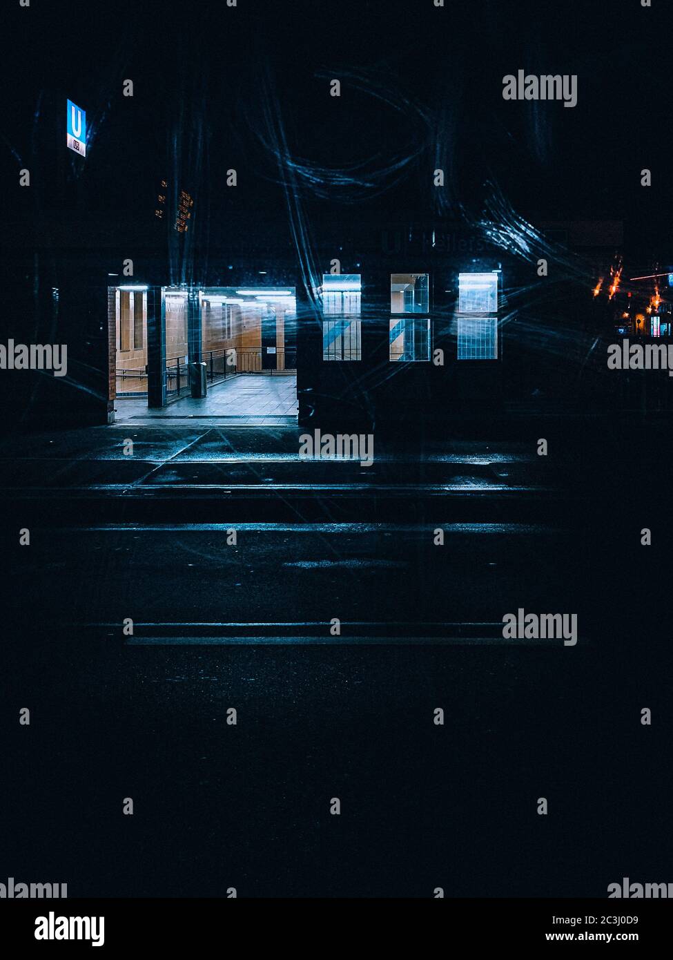 Vertical shot of an empty building with lights on at night Stock Photo ...