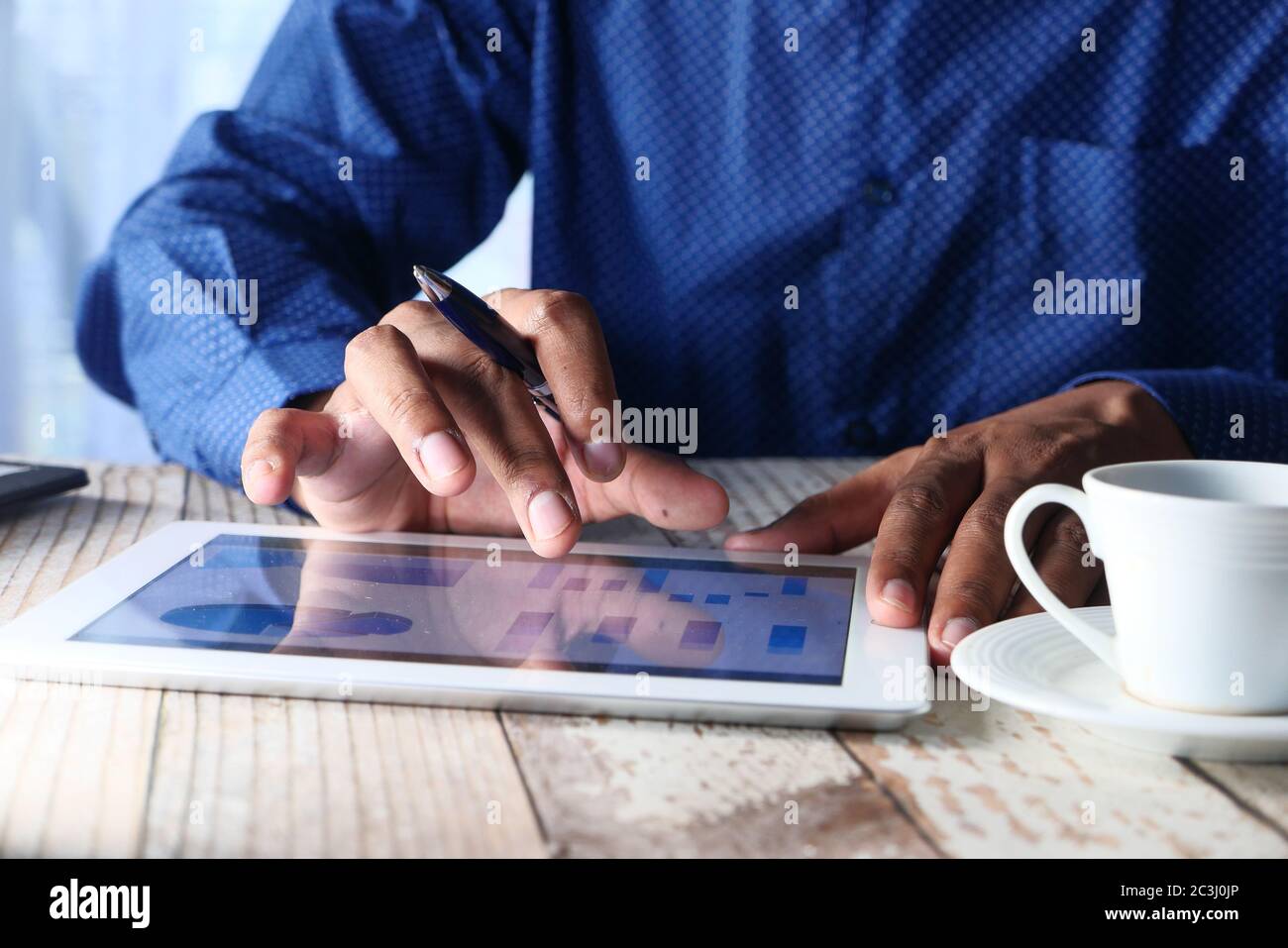 man's hand working on digital tablet at office desk, using self created ...