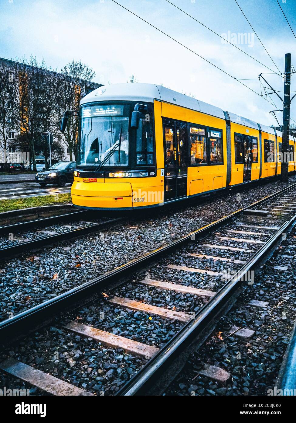 Vertical shot of a yellow train in motion on the outdoor railway ...