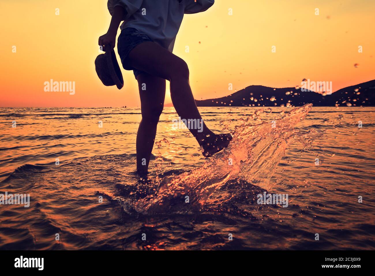the women play water splash on the beach between sunset Stock Photo - Alamy