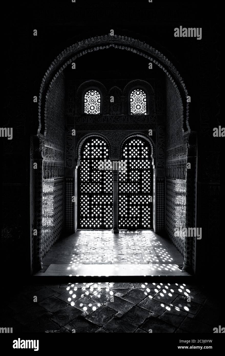 Arabesque style ornate window detail, with sunlight shining through ...