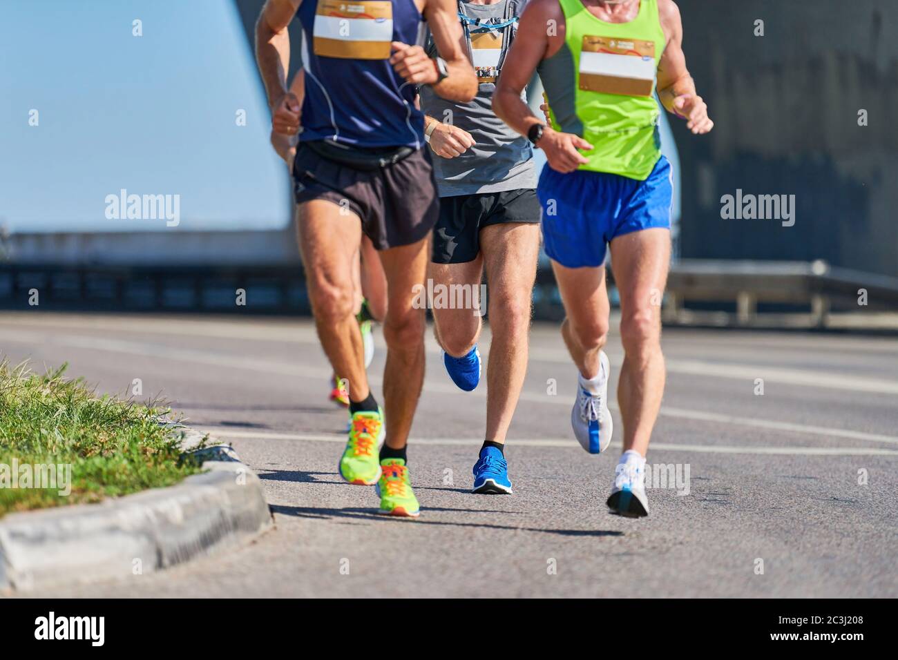Marathon runners on city road. Running competition. Street sprinting ...