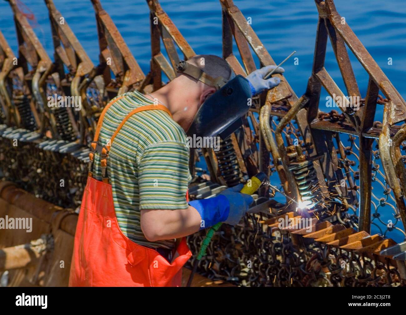 repairing the dredges onboard a king scallop fishing vessel Stock Photo ...