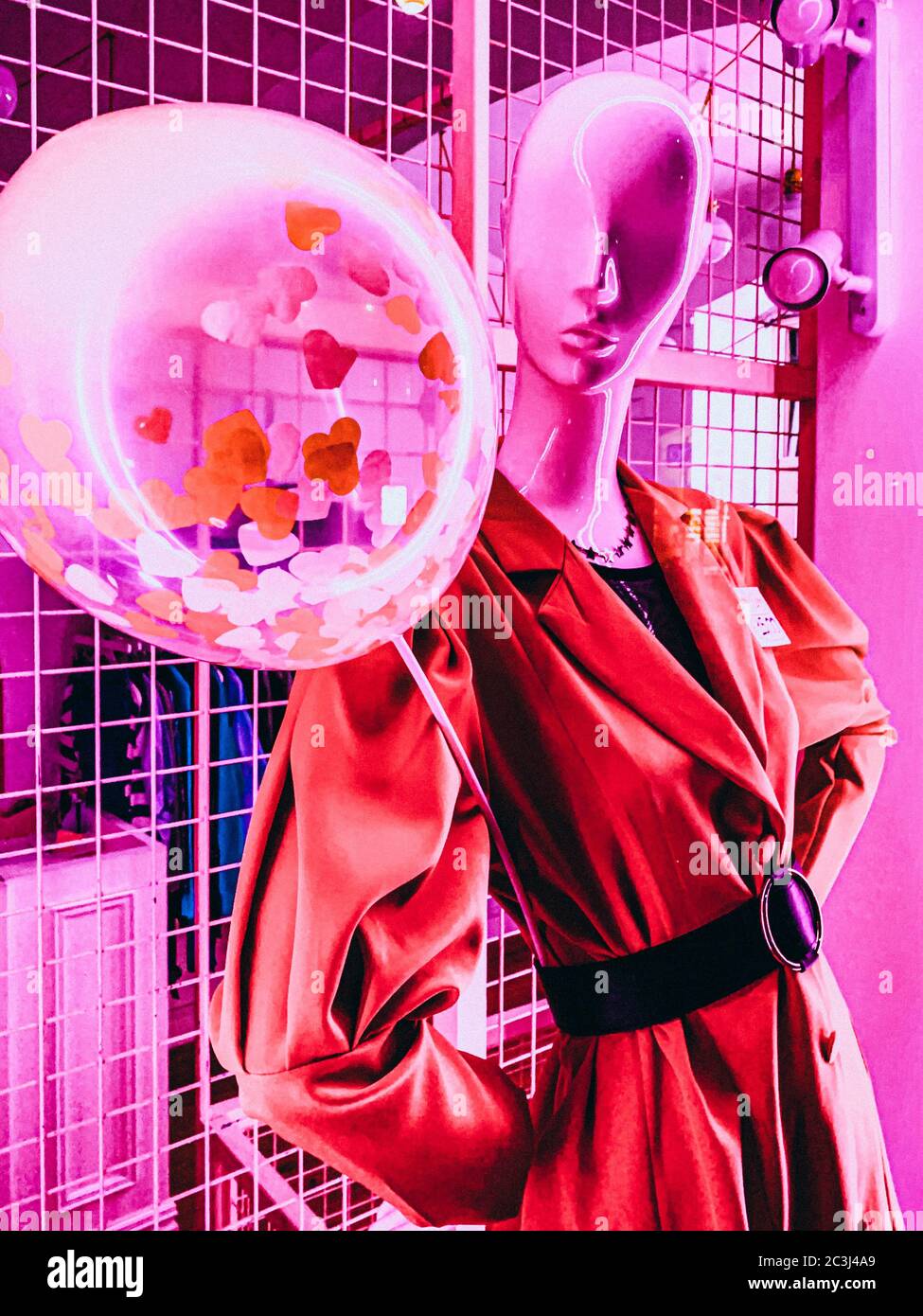 Closeup vertical illustration of a pink mannequin with a red coat and a ...