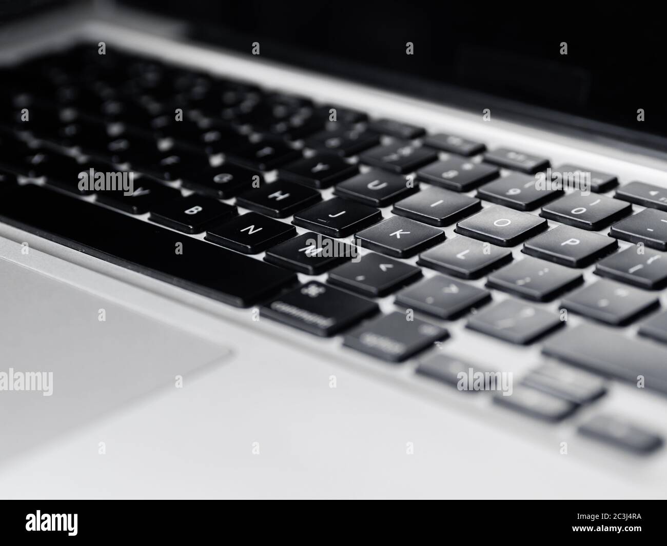 black qwerty keyboard of a gray laptop close-up Stock Photo - Alamy