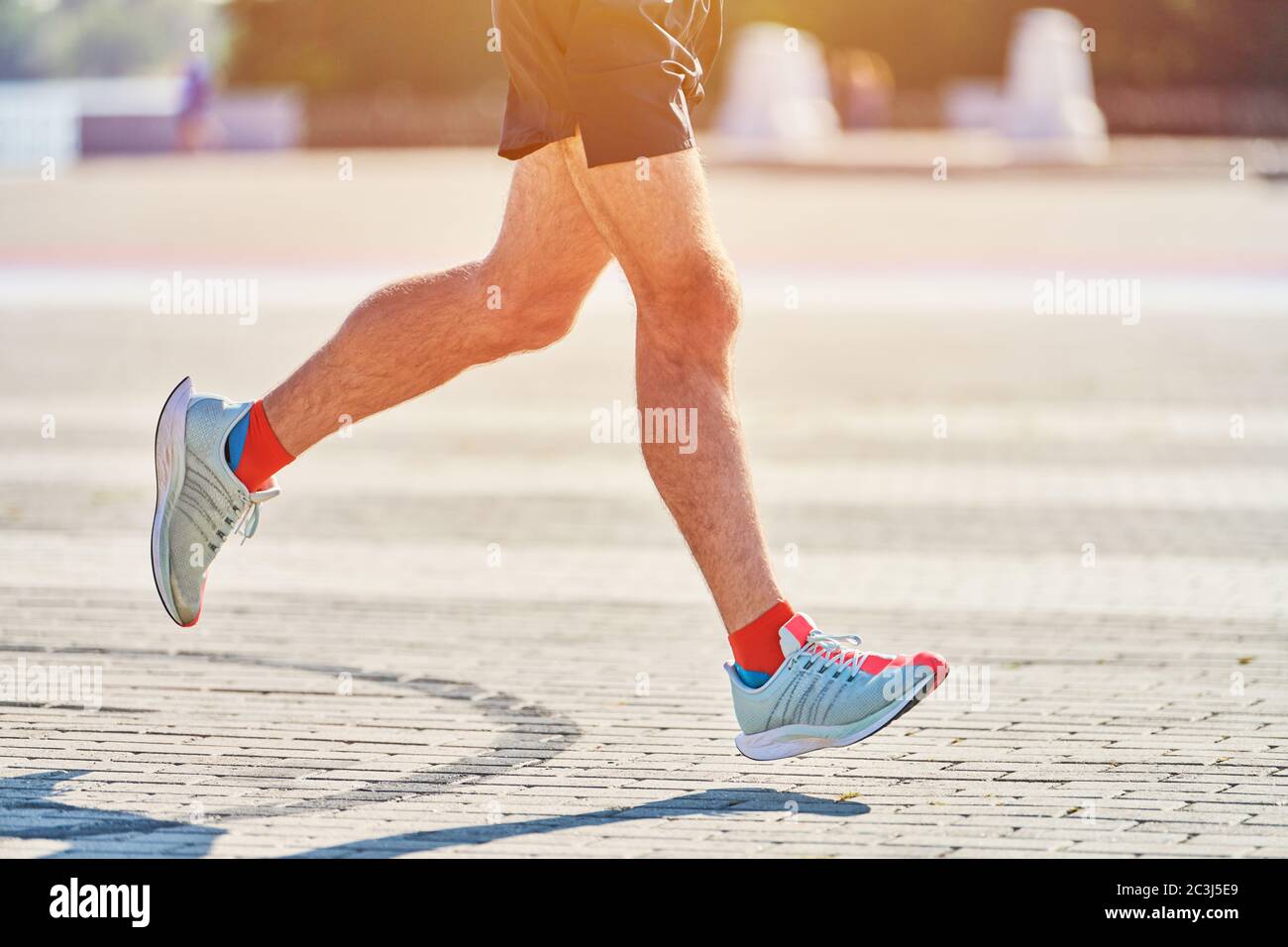 Running man. Athletic man jogging in sportswear on city road. Healthy ...
