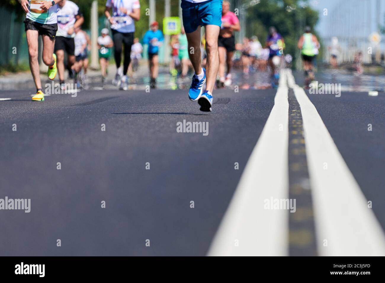 Runners on city road. Running marathon, copy space. Street sprinting ...