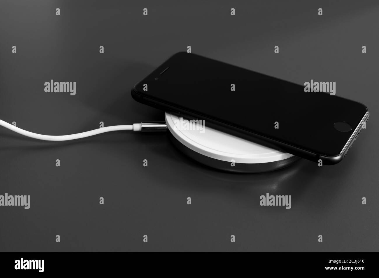 Close-up mobile phone charging on a wireless charging device Stock ...