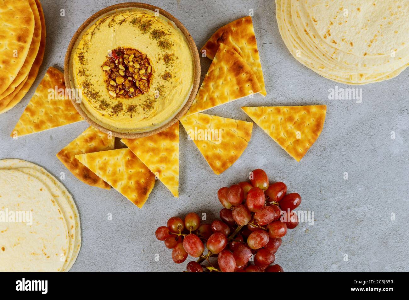 Jewish dinner table with pita bread, hummus and grapes on white ...