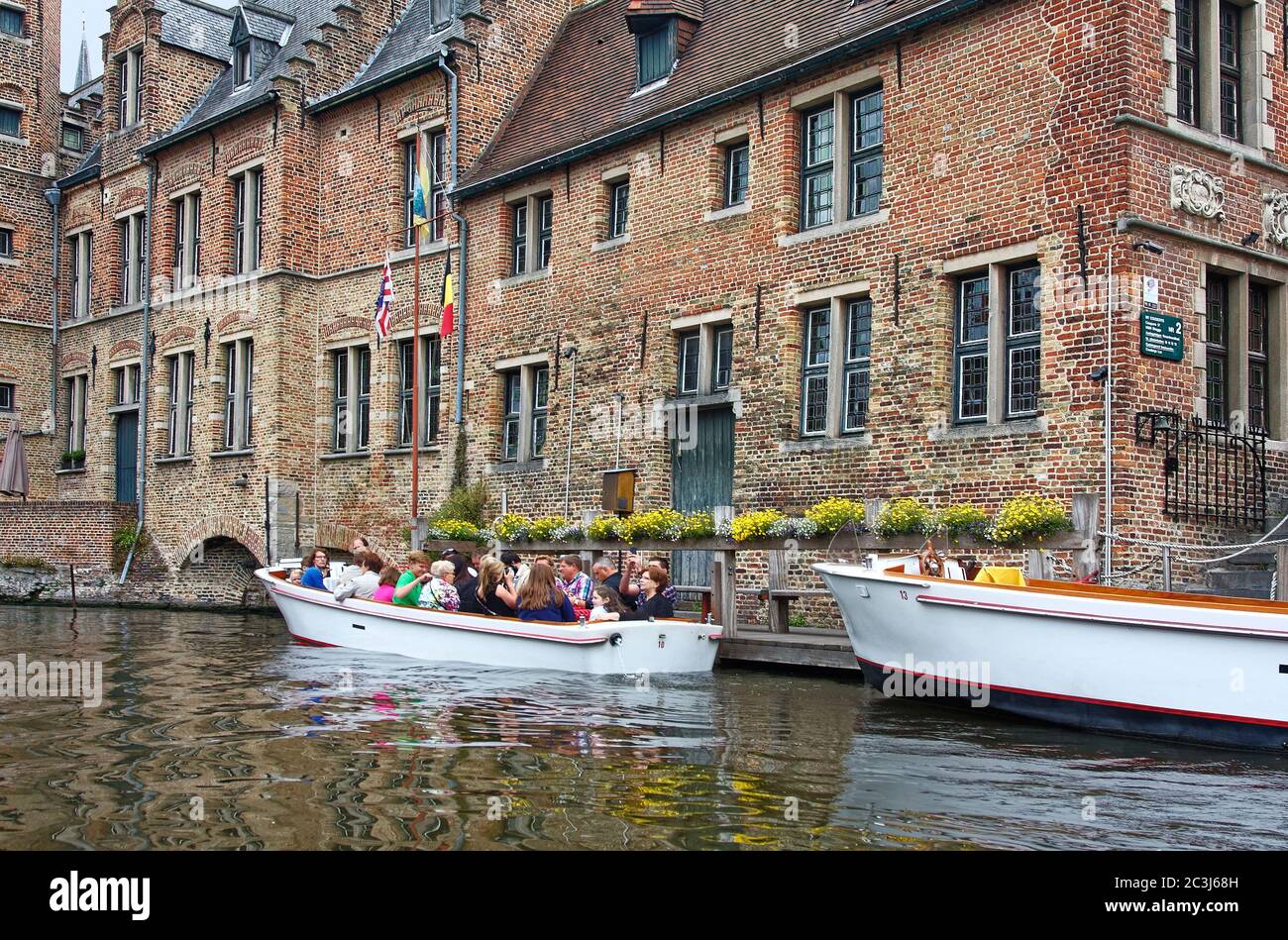 canal scene, 2 boats, tourists, brick buildings, Flemish architecture ...