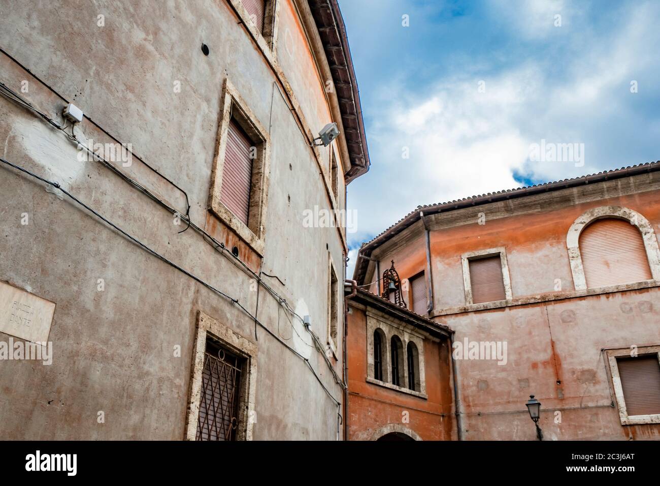 A view of Piazza Dante. Ancient building with arch, three windows and ...