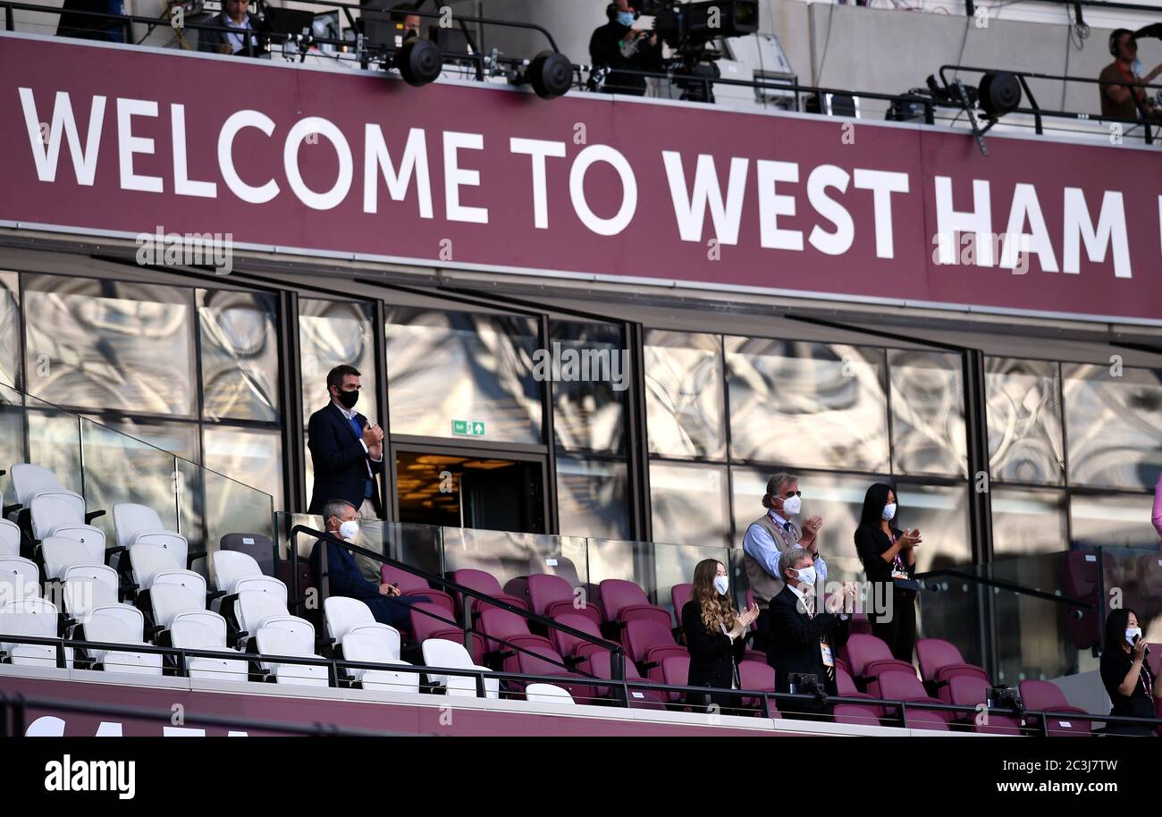 People in the directors box clap the teams as they walk out before ...