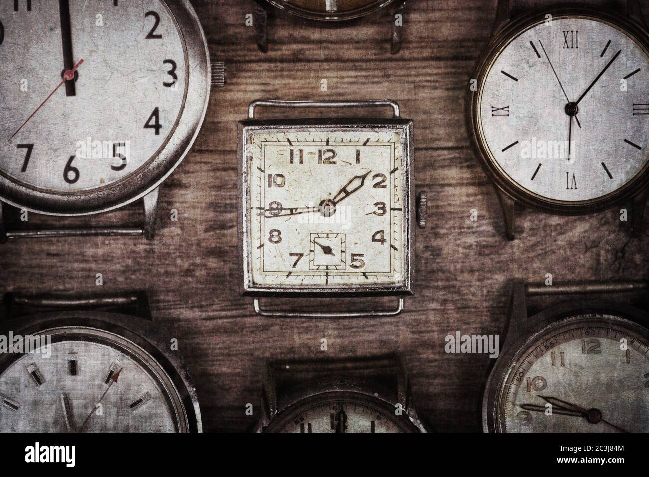 A selection of retro and antique watches over old wood background ...