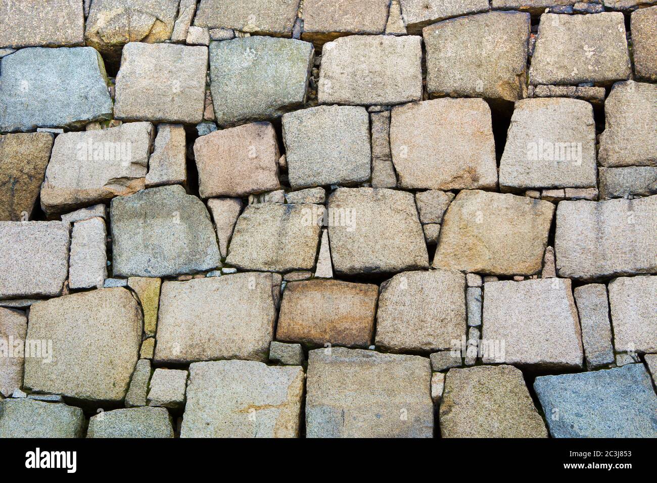 Osaka castle wall detail. Background of colourful stone blocks Stock ...