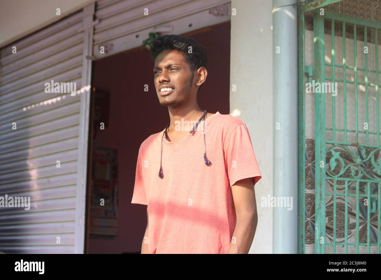 person on sunlight,over background as portrait of metal shutter gate ...