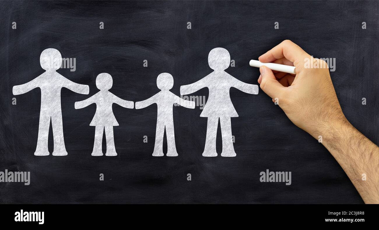 Social issues, family concept. Hand with chalk, sketches a family on ...