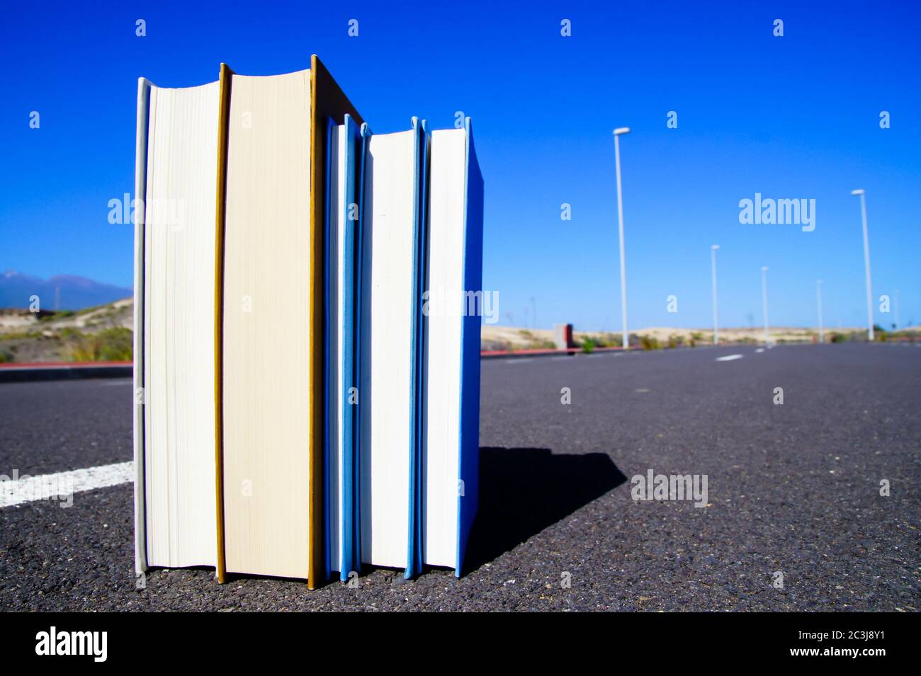On the Road Literature Concept Books over Asphalt Stock Photo - Alamy