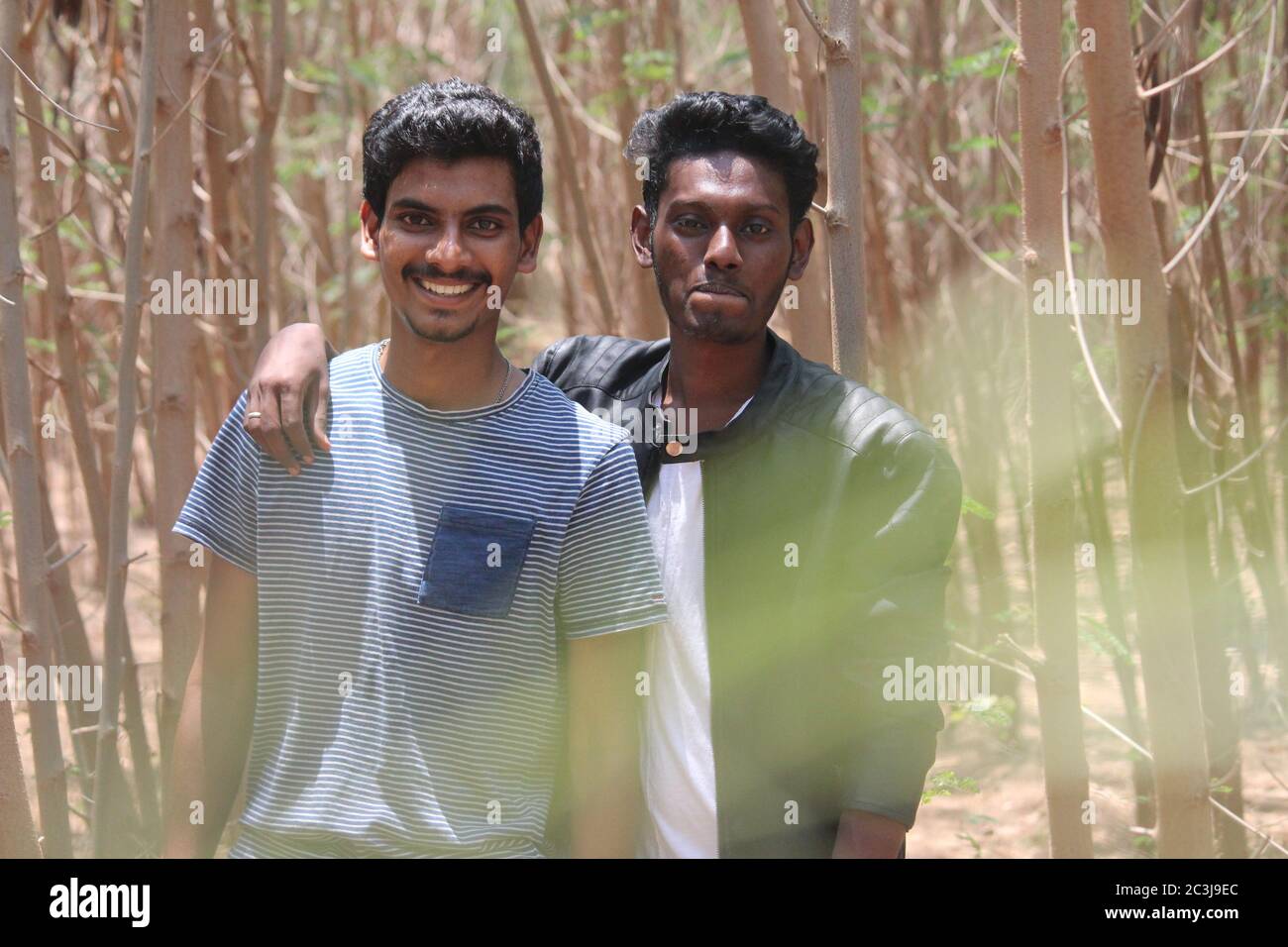 Portrait of two friends smiling at camera,over background as portrait ...