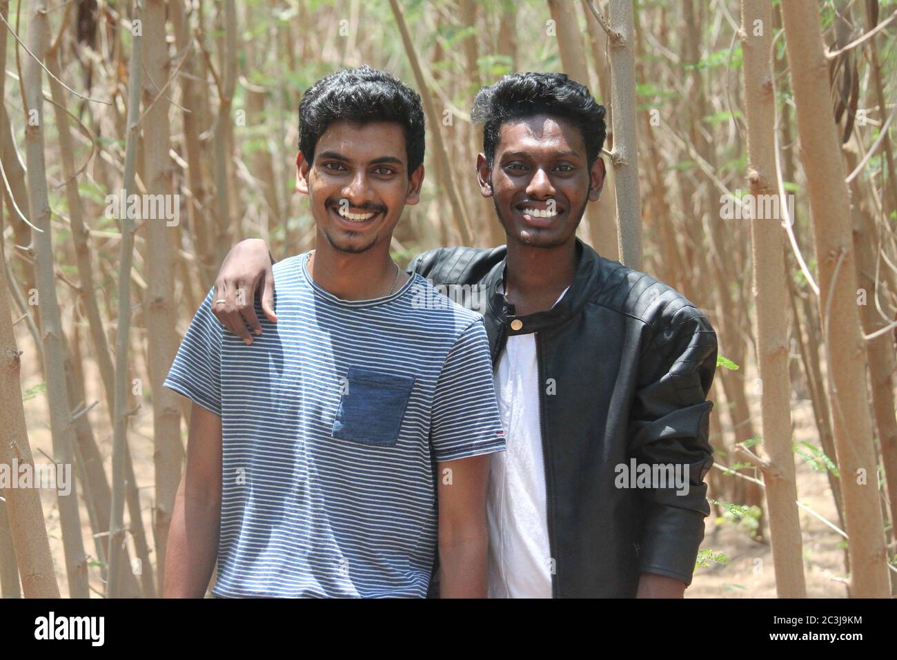 Portrait of two friends smiling at camera,over background as portrait ...