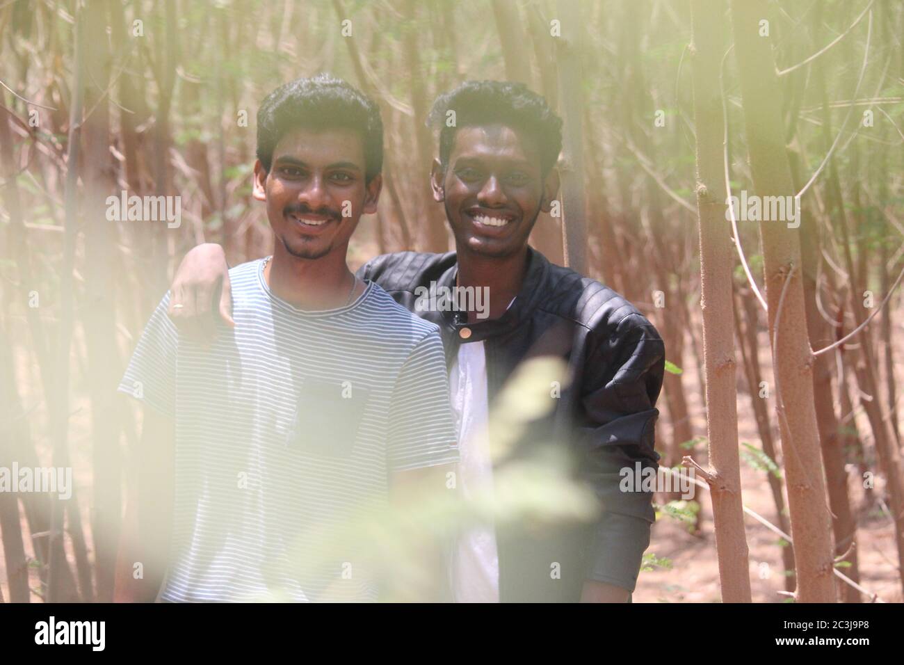 Portrait of two friends smiling at camera,over background as portrait ...