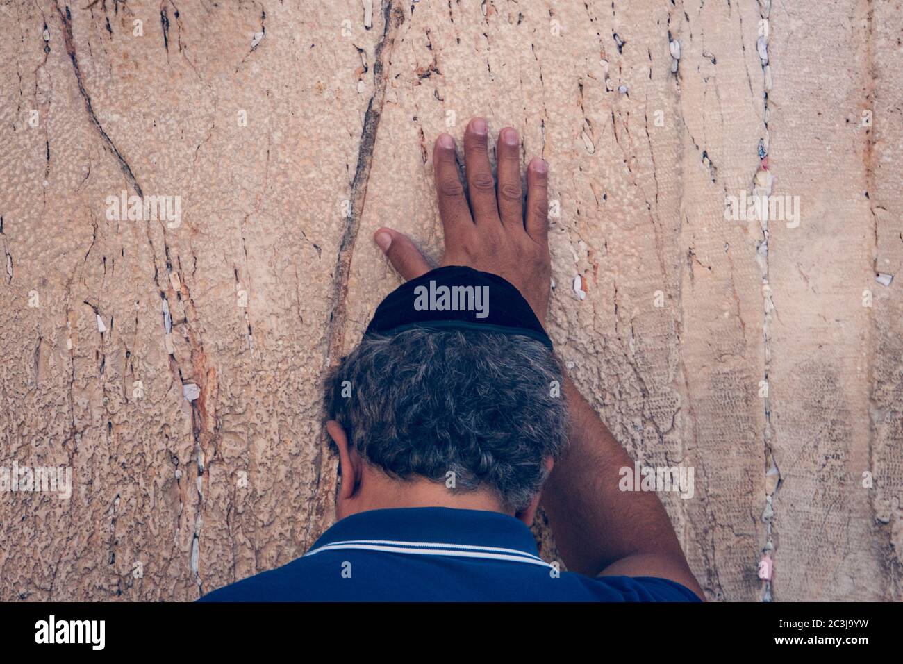 Jewish Orthodox man praying with strong emotions near the stones of the ...