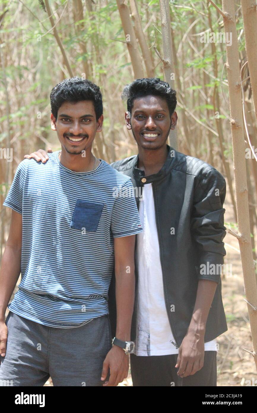 Portrait of two friends smiling at camera,over background as portrait ...