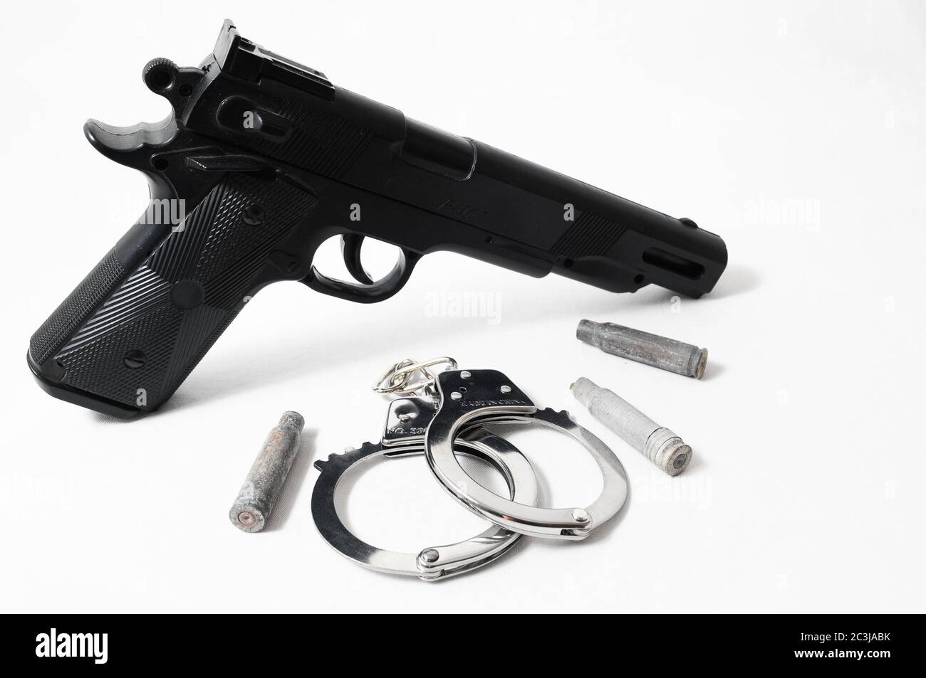 Pistol Gun and Handcuffs on a White Background Stock Photo - Alamy