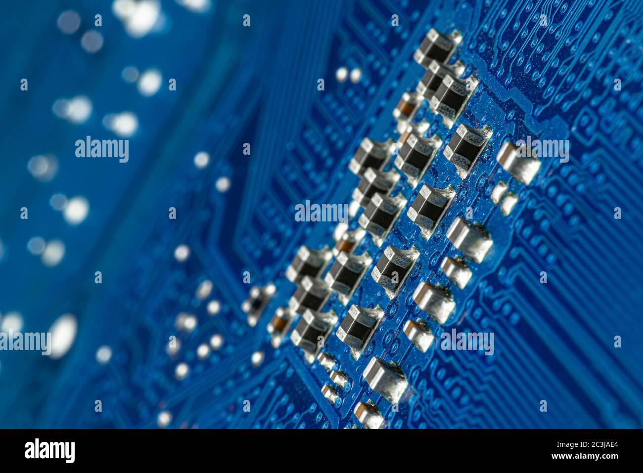 Macro photo of electrical paths on blue circuit board, visible ...