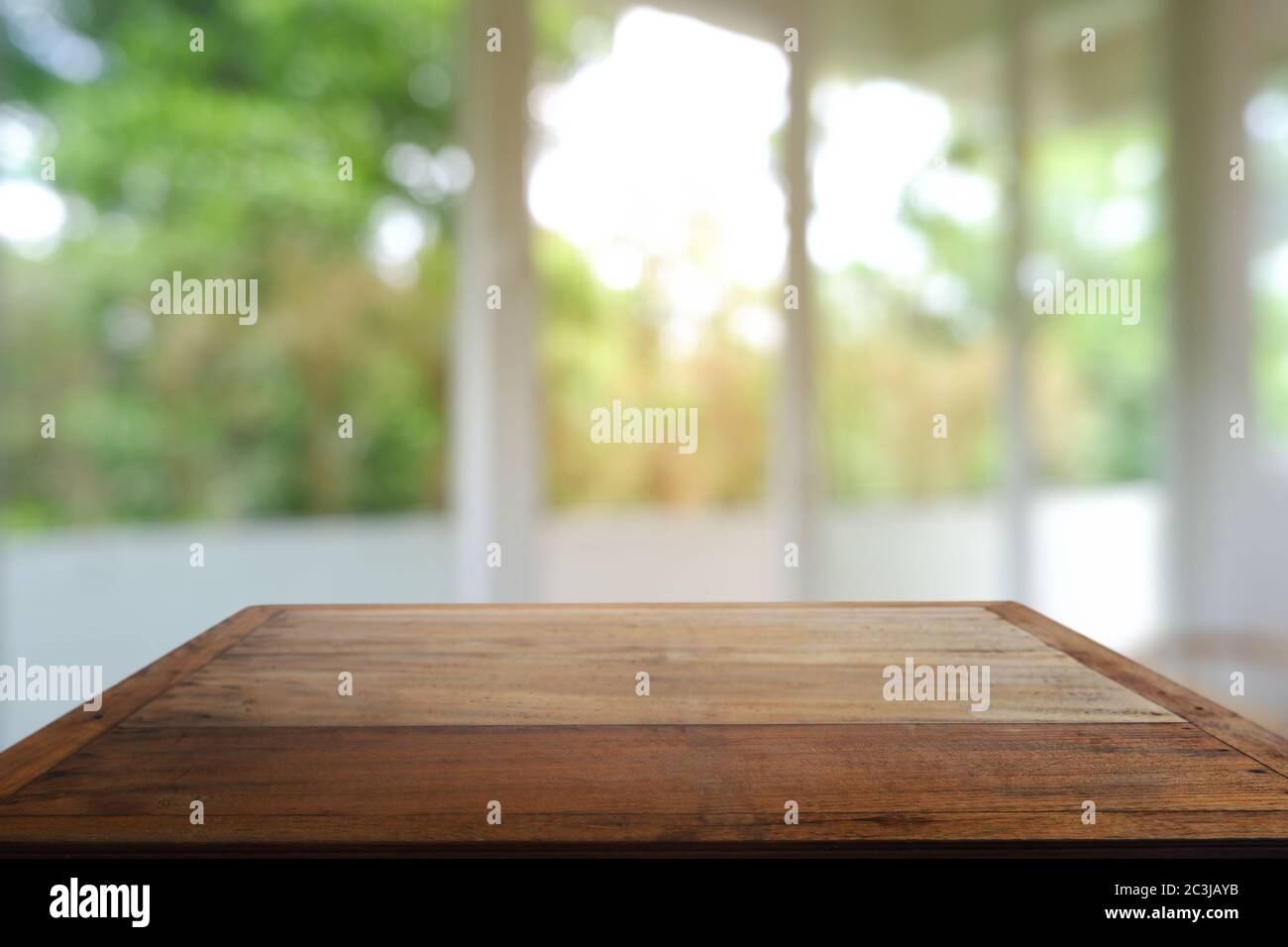 Empty wooden table in front of abstract blurred Cafe, restaurant. For ...