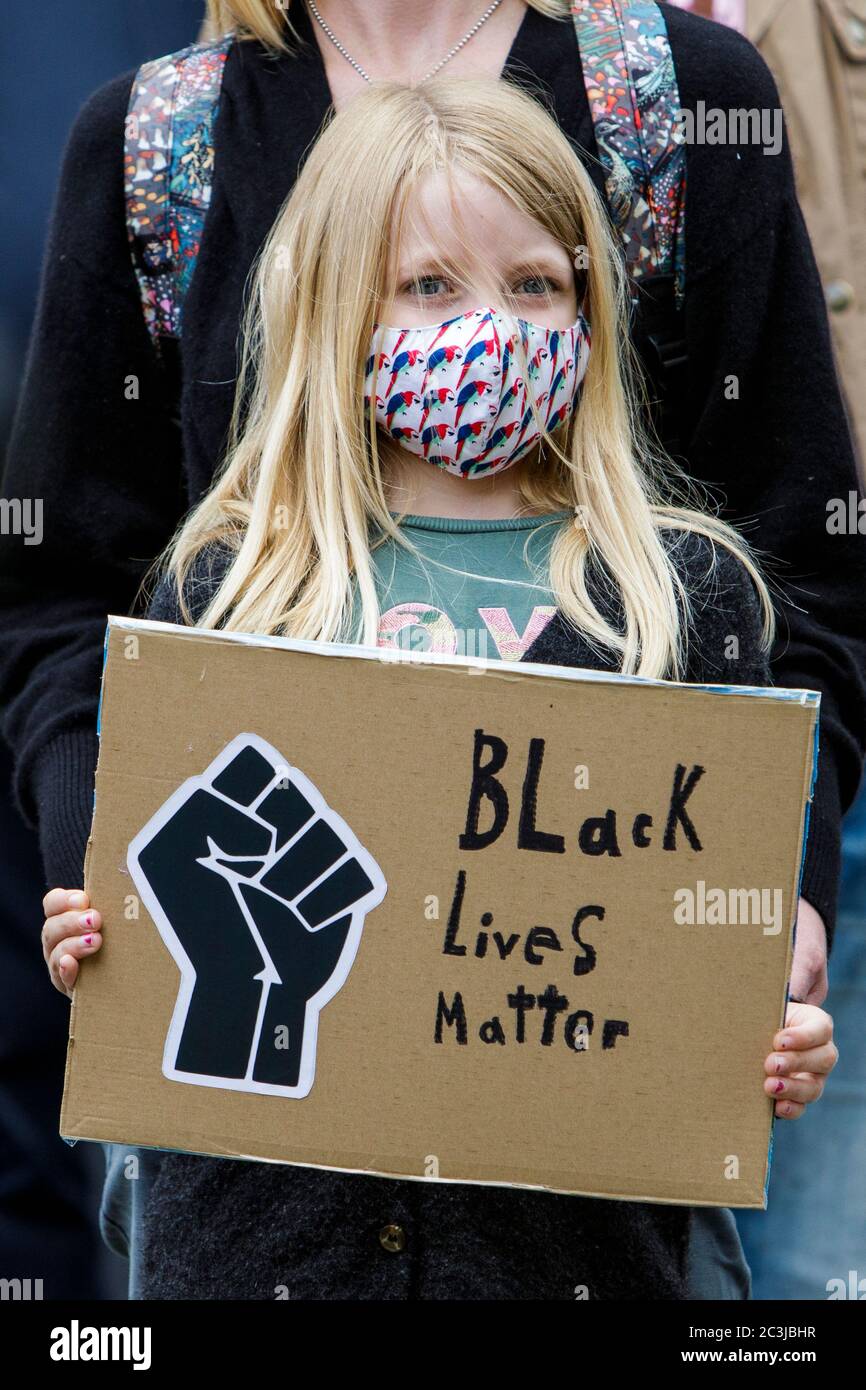 Chippenham, Wiltshire, UK. 20th June, 2020. A young girl holds up a ...