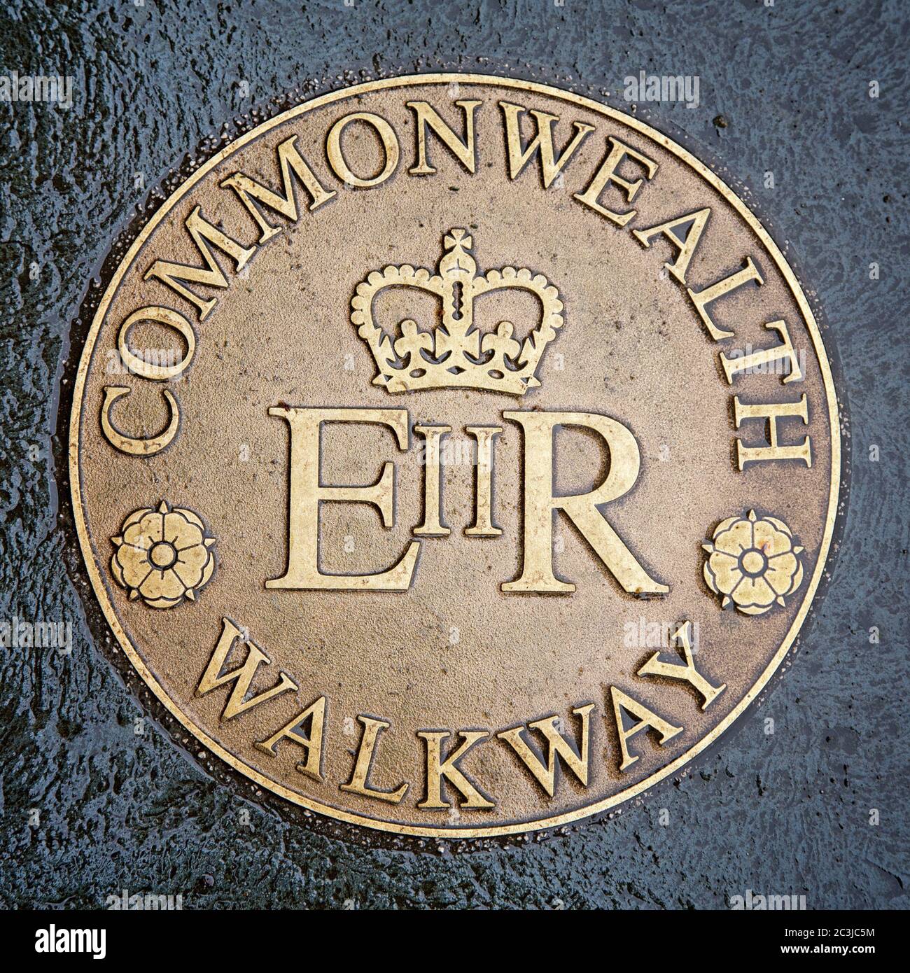 Commemorative Commonwealth Walkway brass plaque. Street sign set in the ...