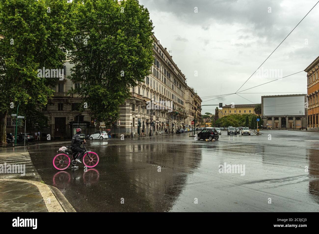 A cyclist crosses the intersection with the traffic light in Piazza San ...