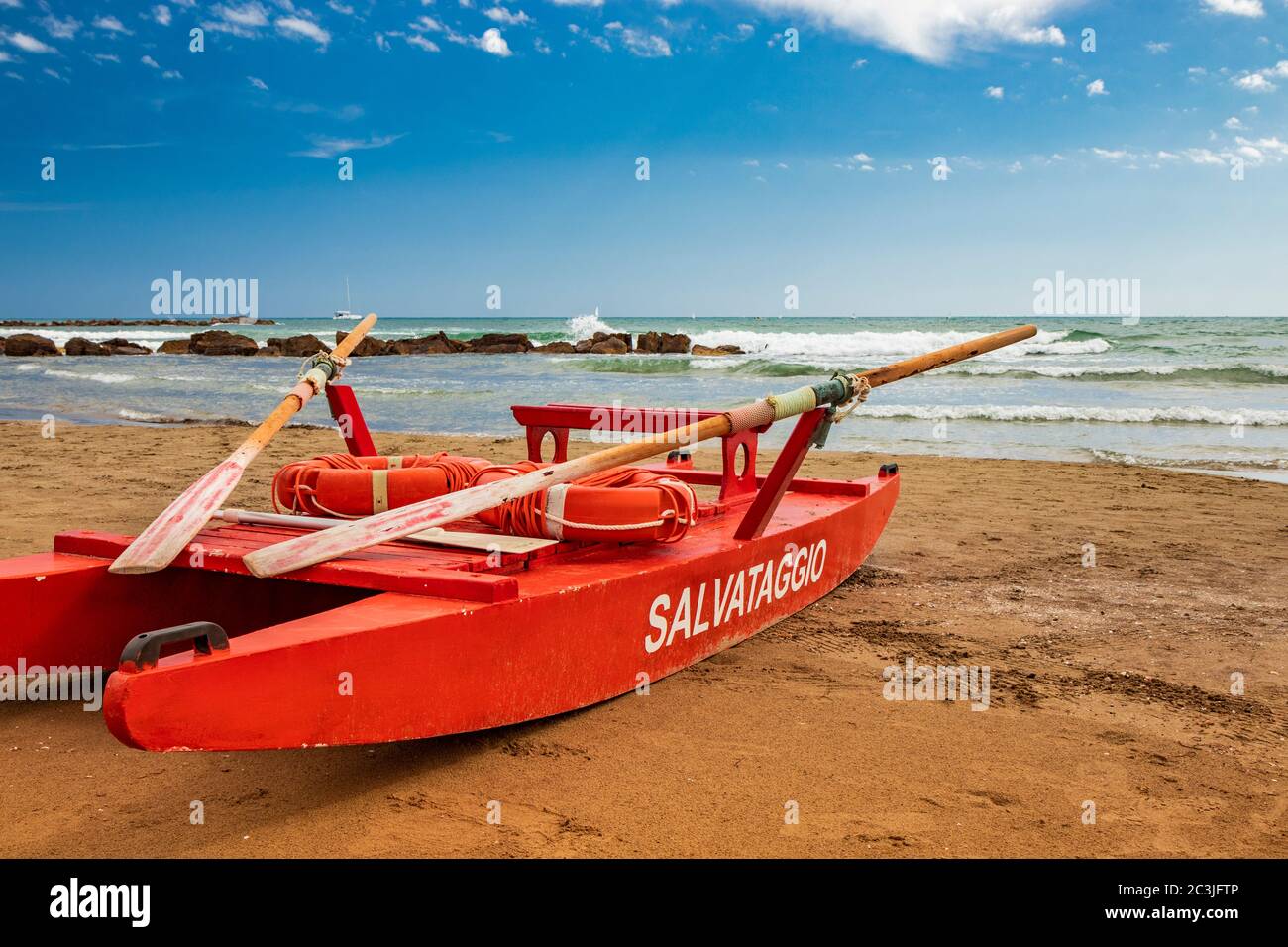 Typical red rescue boat, with oars, used by Italian lifeguards ...