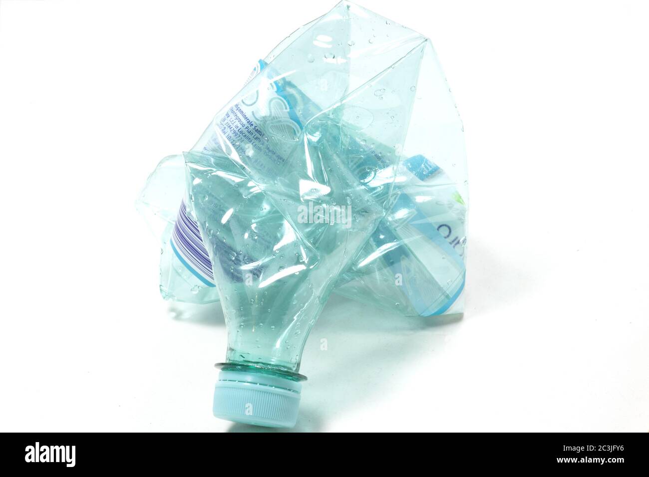 Closeup view of a crashed empty water bottle isolated on a white ...