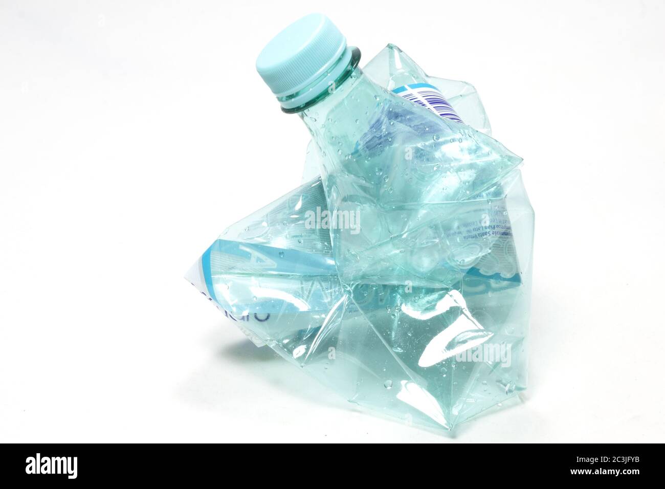 Closeup view of a crashed empty water bottle isolated on a white ...