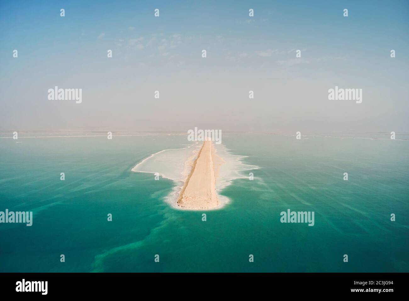 Road on Dead Sea surface. The southern part of the Dead Sea, is divided ...