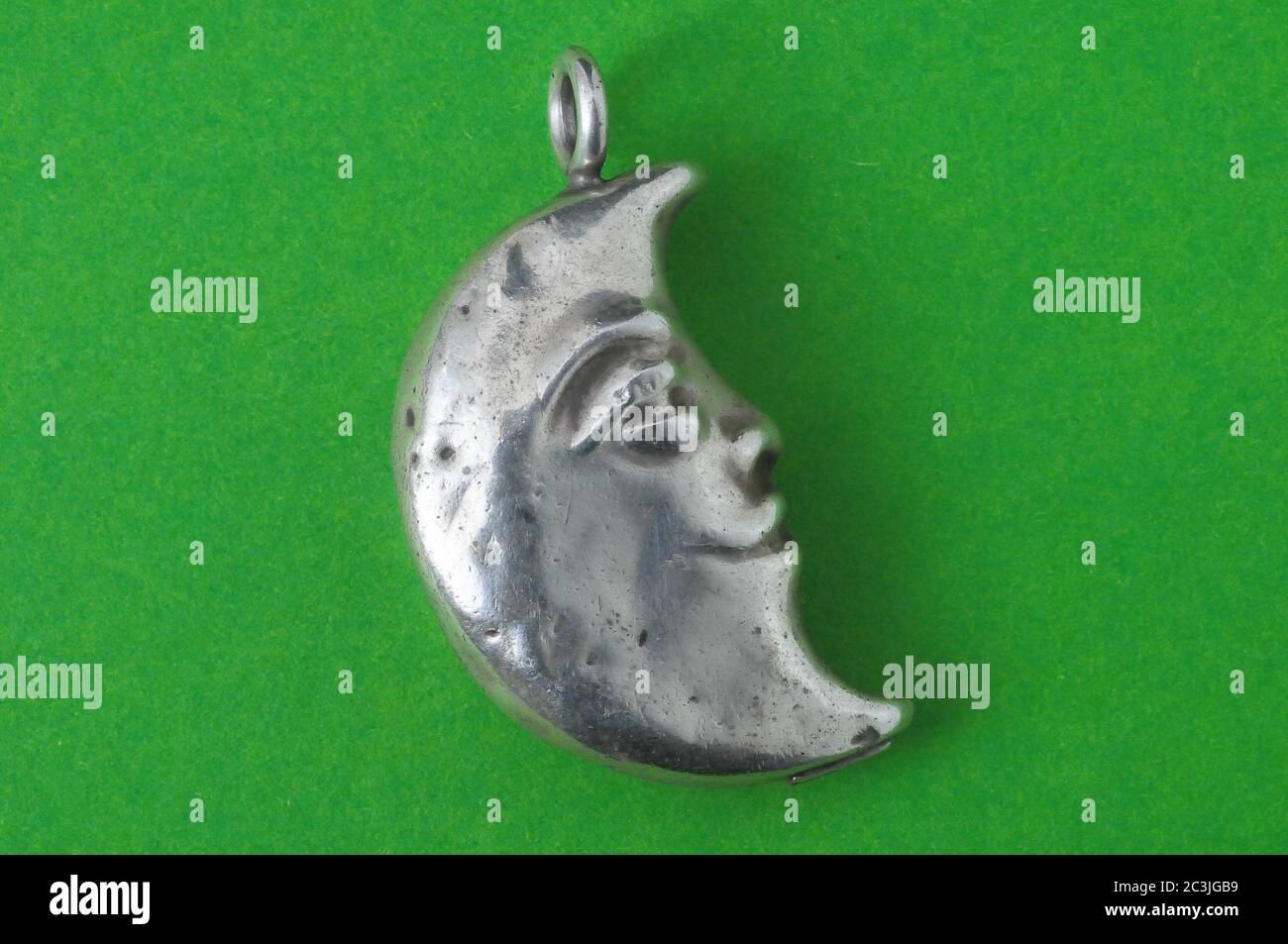 Half Moon Silver Jewel over a Colored Background Stock Photo - Alamy