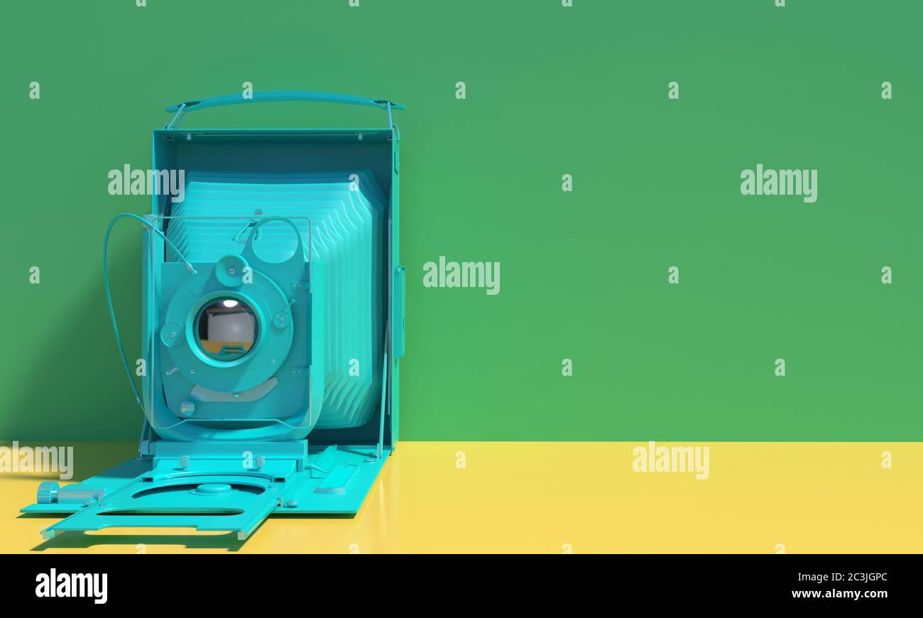 Old retro camera in monochrome turquoise color isolated on green and ...