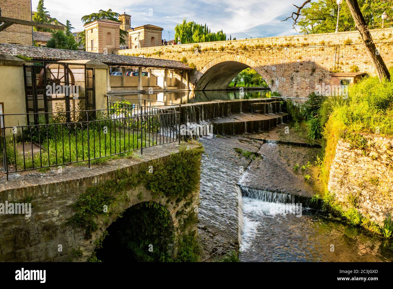The ancient wash-house and the masonry bridge over the river, in the ...