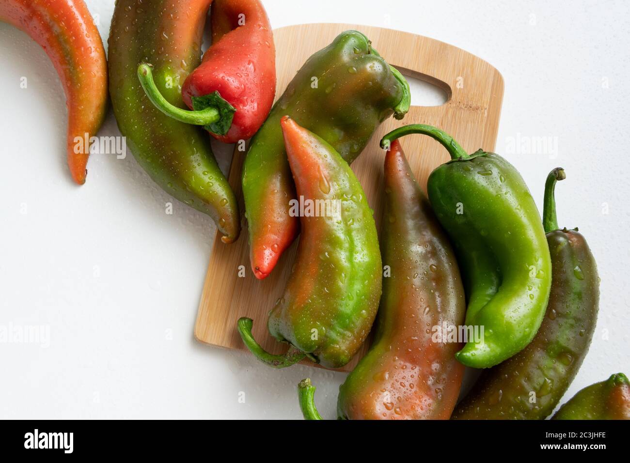 Raw peppers on white background Stock Photo - Alamy