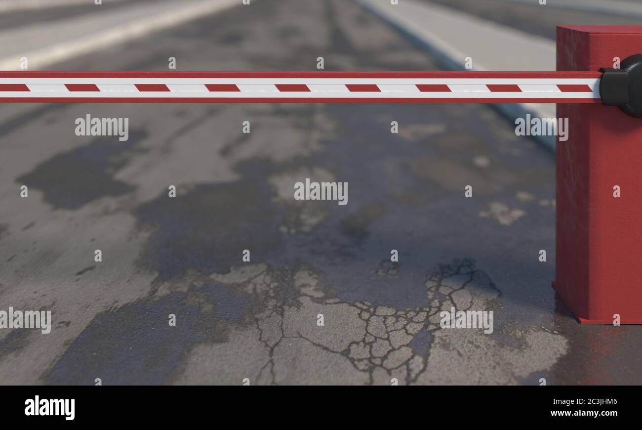 Red lowered road barrier close-up on a blurred background of wet ...