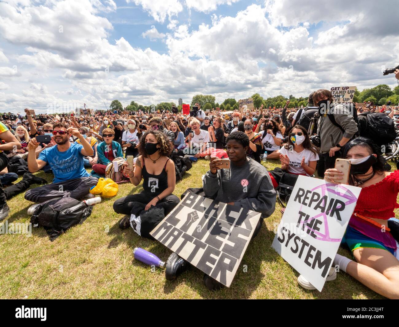London. UK . June the 20th 2020. BLM protesters sitting and listening ...