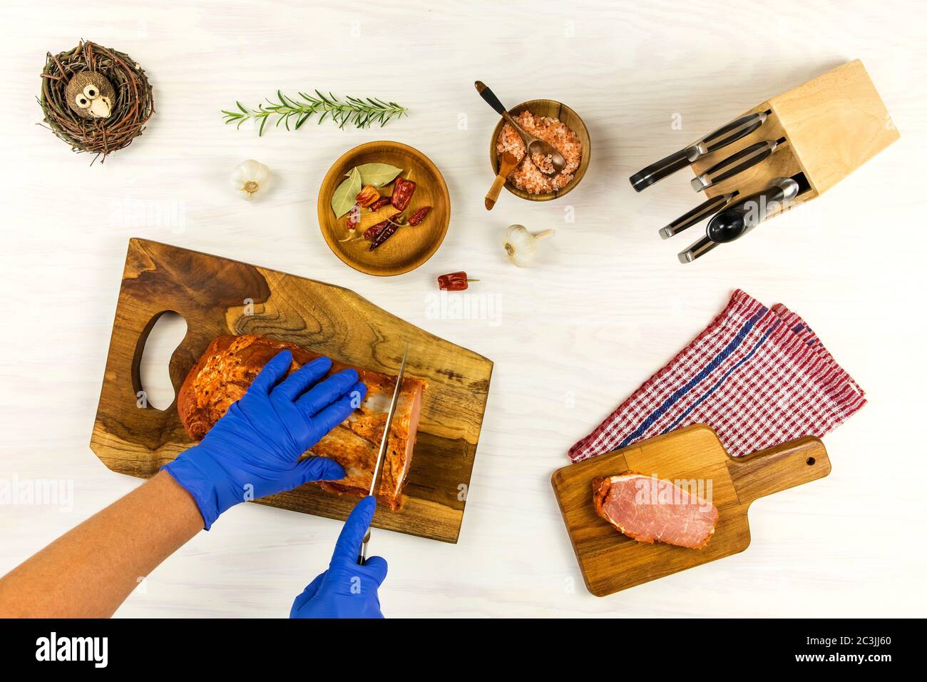 Butcher cutting pork meat on kitchen wooden cutting board. Kitchen ...