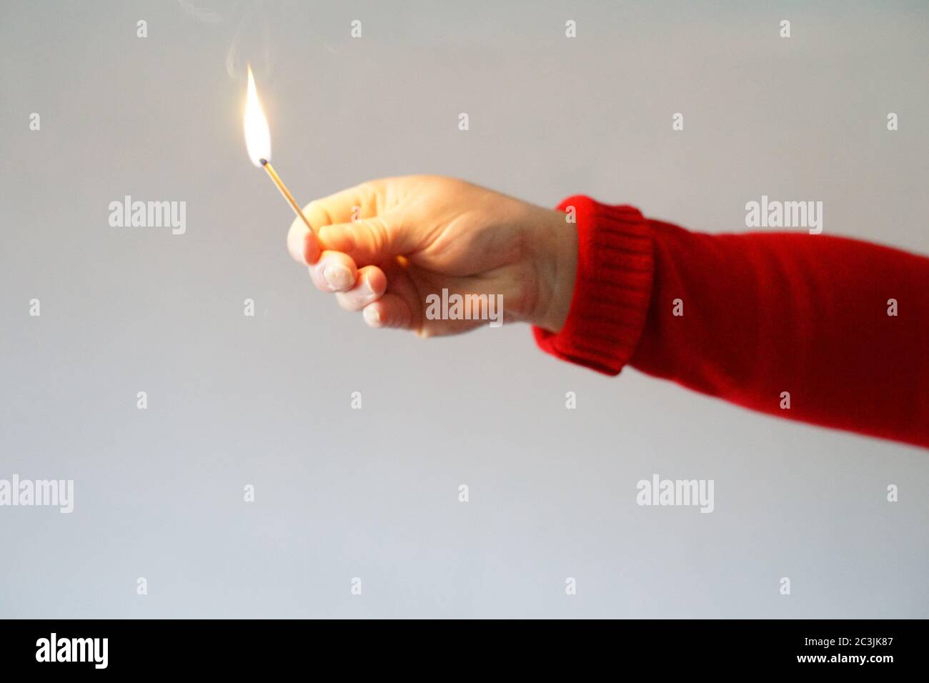 A shallow focus shot of a person holding a burning matchstick Stock ...
