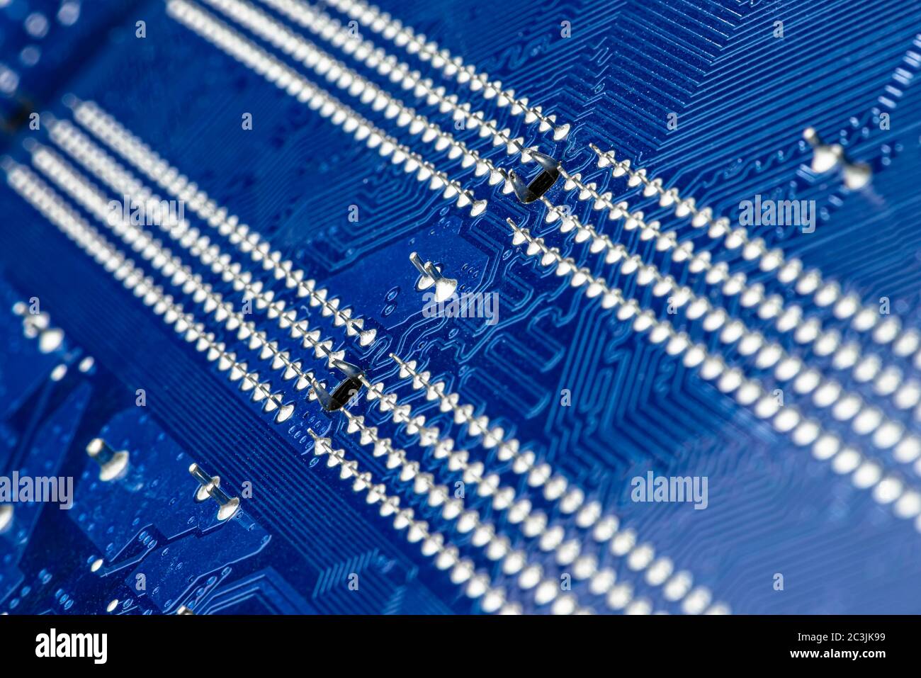 Macro photo of electrical paths on blue circuit board, visible ...