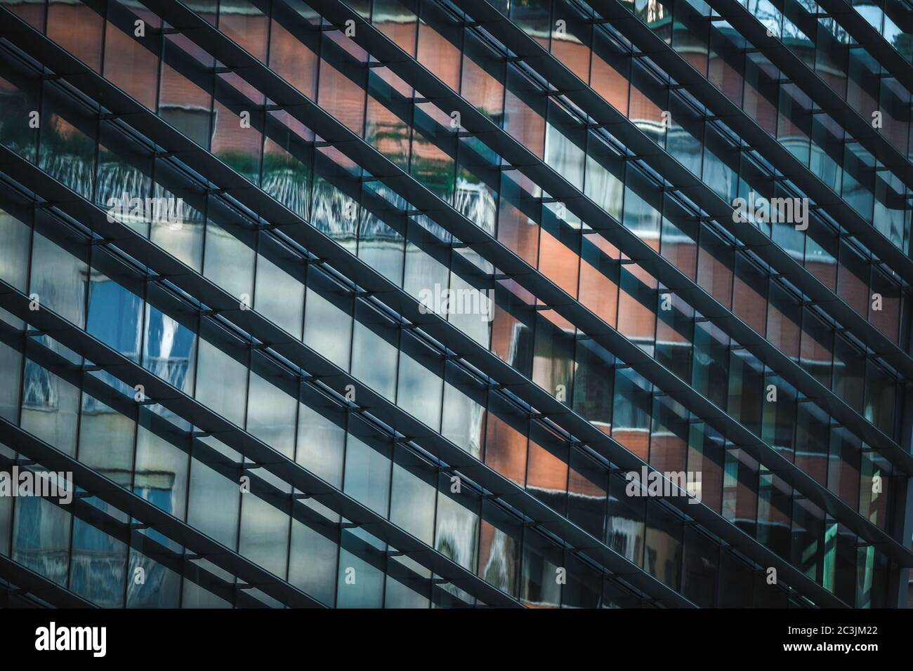 Low angle shot of a modern building glass facade with a reflection ...