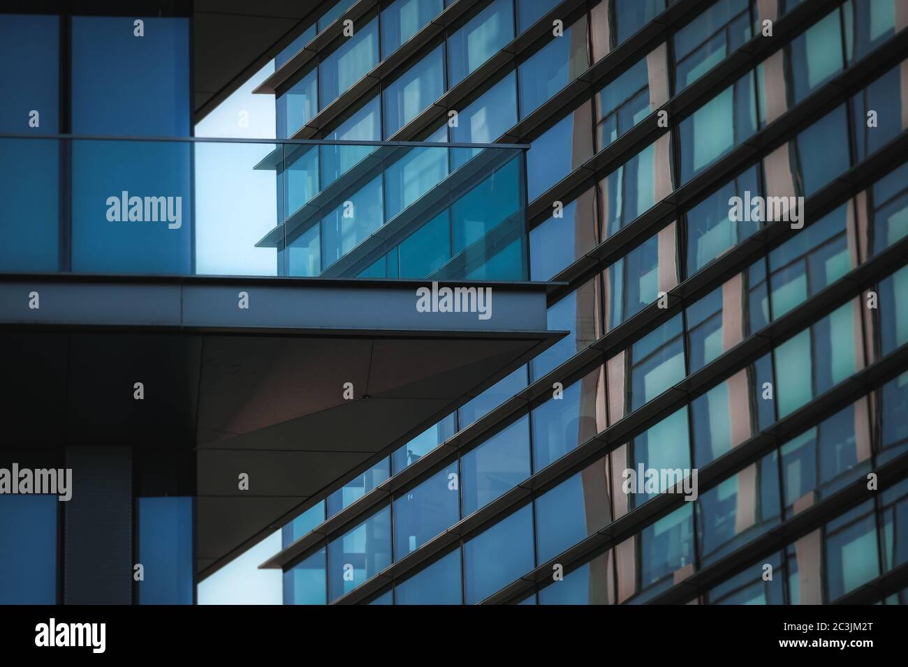 Low angle shot of a modern building glass facade with a reflection ...